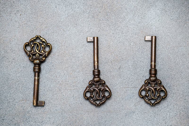 Three Old Vintage Bronze Keys on an Abstract Gray Background. View from ...