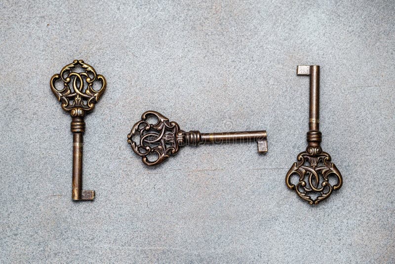 Three Old Vintage Bronze Keys on an Abstract Gray Background. View from ...