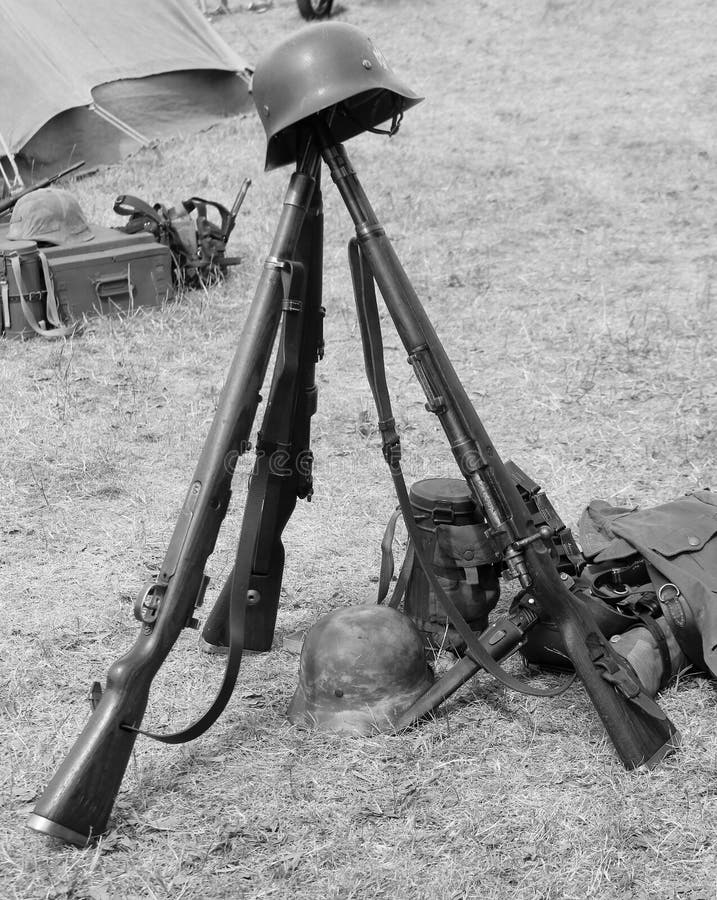 Three Old War Rifles and Helmets of Dead Soldier Stock Photo - Image of ...