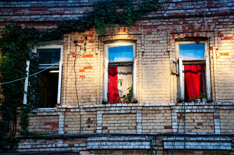 Three Open Windows on Brick Building in the Evening Stock Image - Image ...