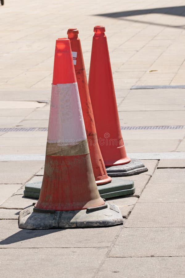 Three Traffic Cones on a Pavement Stock Image - Image of pavement, tape ...
