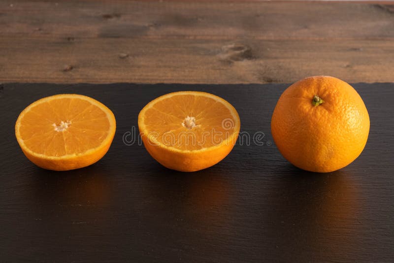 Three Oranges on a Black Stone Stock Image - Image of artwork ...