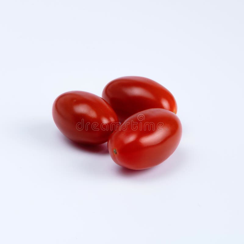 Three Oval Plums, Small Tomatoes on a Distinctly White Background Stock ...