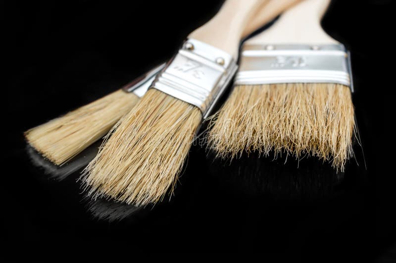Three Paint Brushes on Black Reflective Background Stock Photo - Image ...