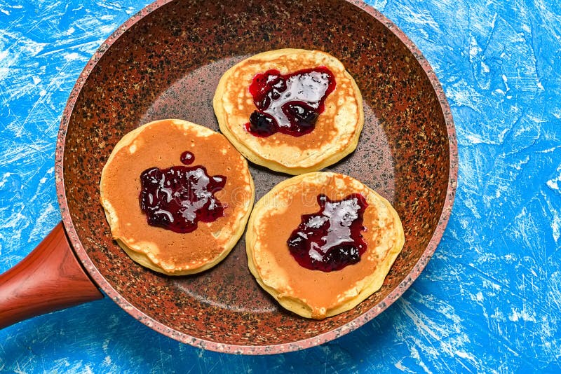 Three Pancake in a Frying Pan, Doused in Raspberry Jam. Close-up of ...