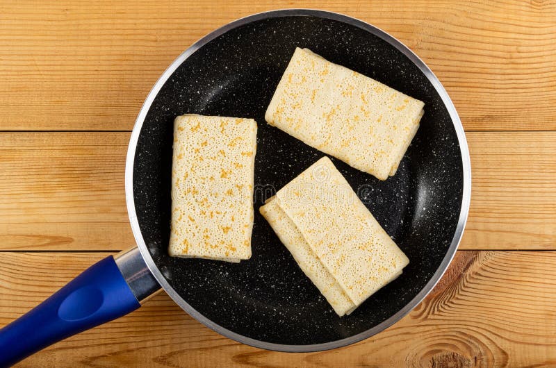Pancake Rolls in Frying Pan on Wooden Table. Top View Stock Image ...