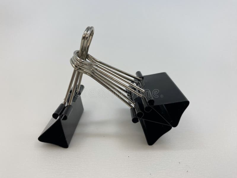 Three Paper Clips Shaped Like an Illustration of a Scale that is Biased ...