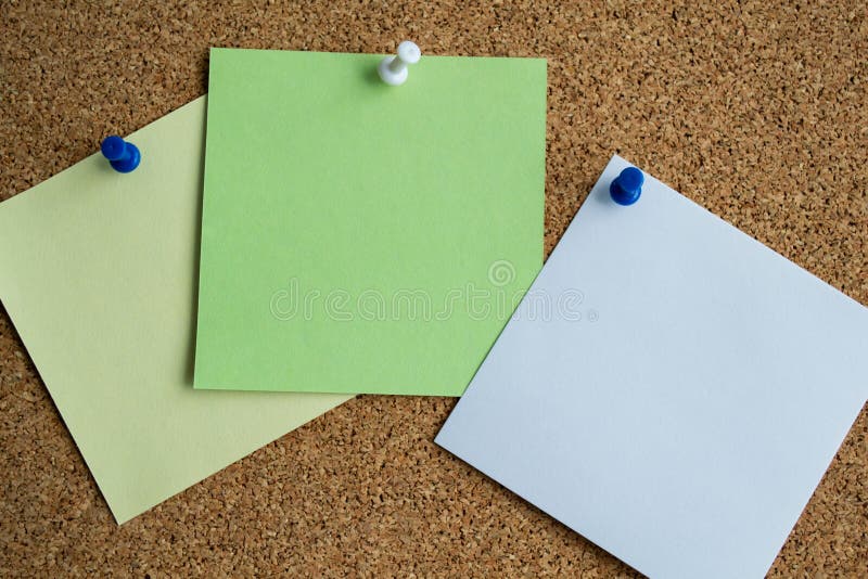 Three Paper Notes Green, White and Yellow Color on a Cork Board ...