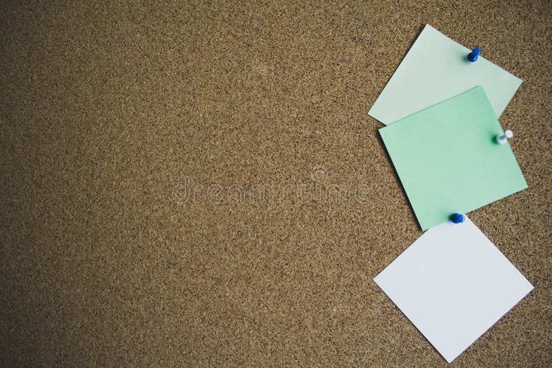 Three Paper Notes Green, White and Yellow Color on a Cork Board ...