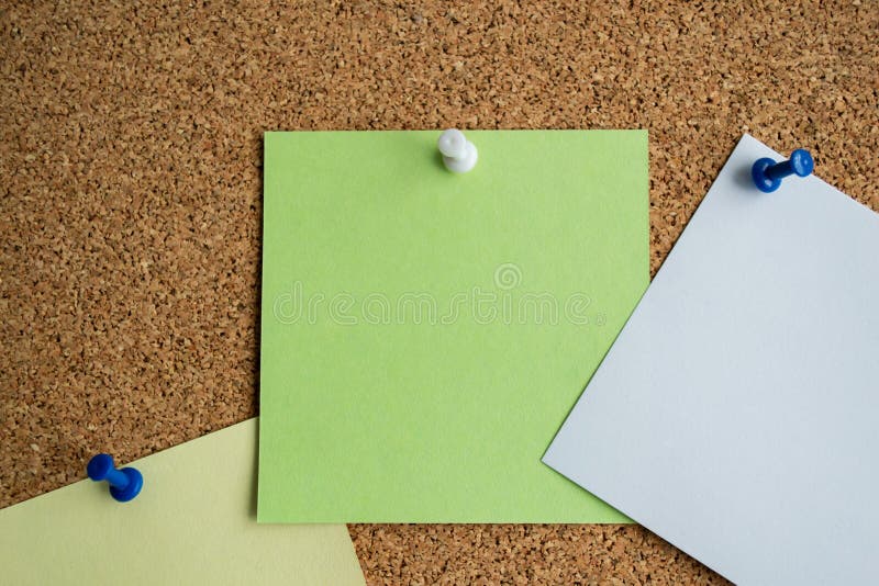Three Paper Notes Green, White and Yellow Color on a Cork Board ...