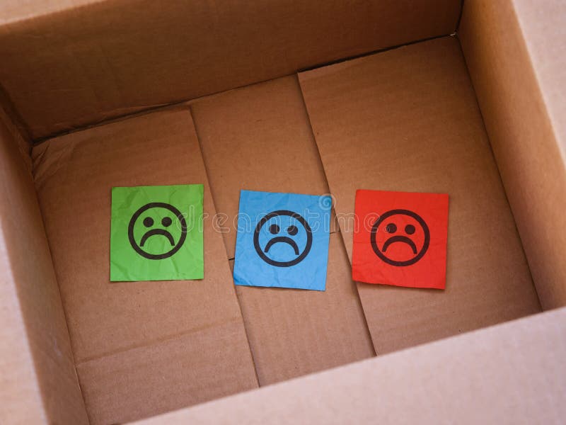 Three Paper Notes with Sad Faces on Them in a Cardboard Box Stock Image ...