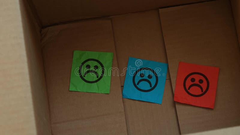 Three Paper Notes with Sad Faces on Them in a Cardboard Box Stock ...