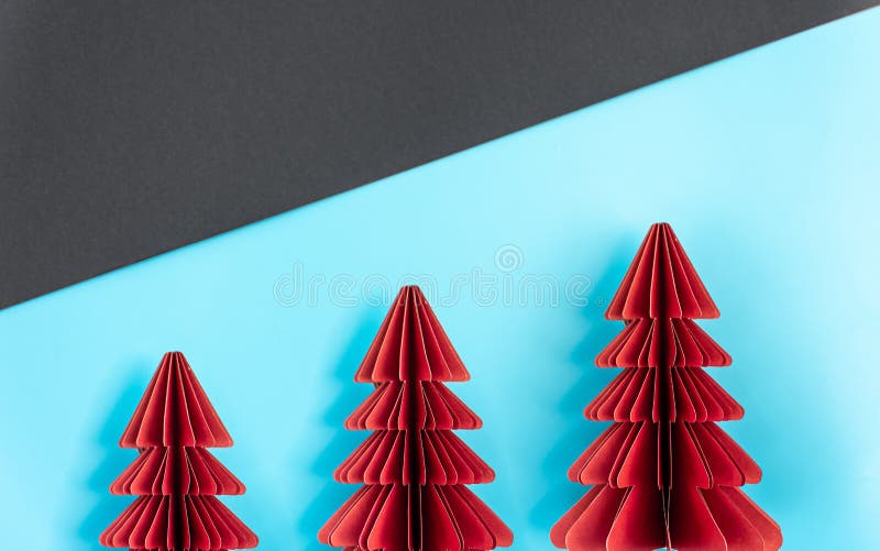 Three Paper Origami Christmas Trees on Blue Background, Flat Lay. Stock ...
