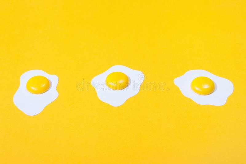 Three Paper Scrambled Eggs-fried Eggs Located on a Yellow Paper ...