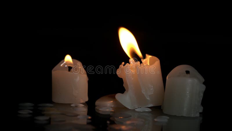 Three Paraffin Candles Burn in a Row on a Black Background with ...