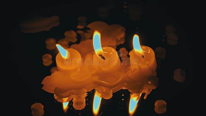 Three Paraffin Candles Burn in a Row on a Black Background with ...