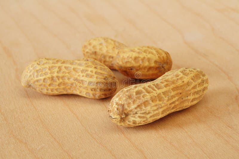 Three Peanuts stock photo. Image of closeup, board, three - 12352842