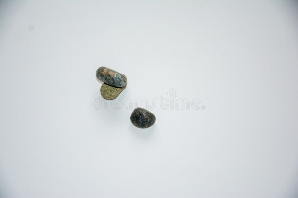 Three Pebbles Creatively Stacked, with a Simple Background Highlighting the Shape of the Stones ...