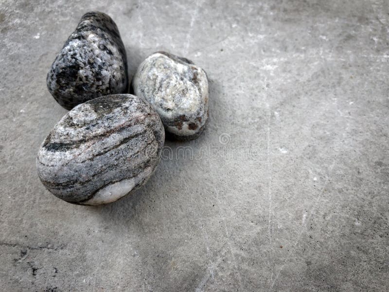 Three Pebbles Gathered Together Against a Flat Surface. Stock Image ...