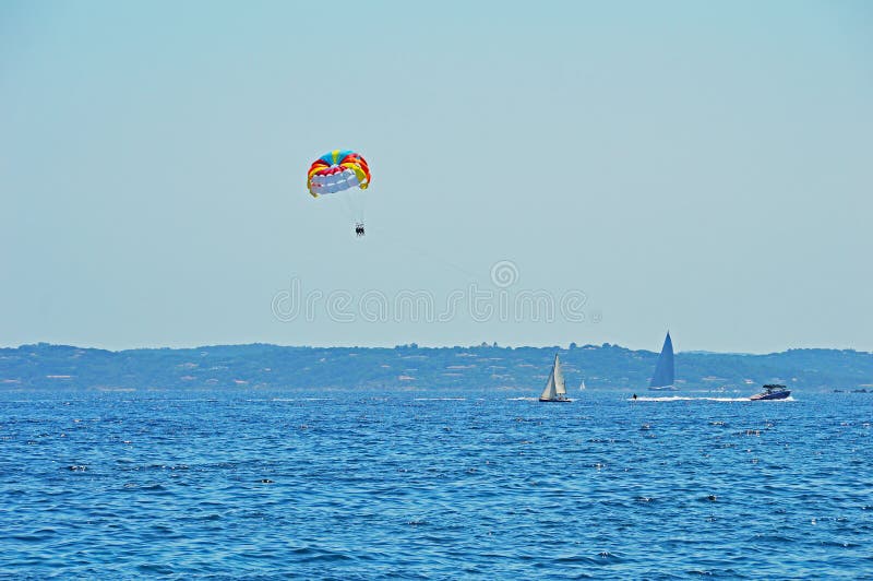 Three People on a Colorful Parasailed Stock Photo - Image of open ...