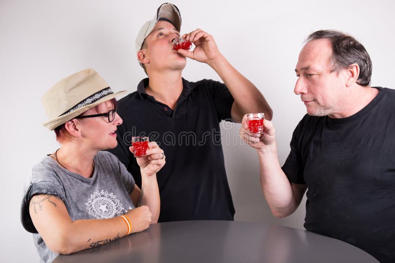 People Taking Shots Of Alcohol