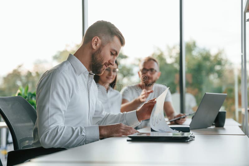 Three People in Formal Clothes are Working in the Modern Office ...