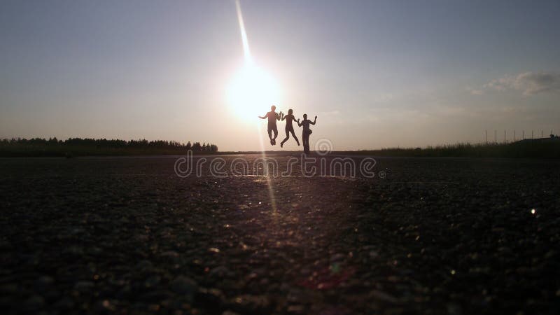 Three People Jumping in Sunset Stock Image - Image of runway, funny ...
