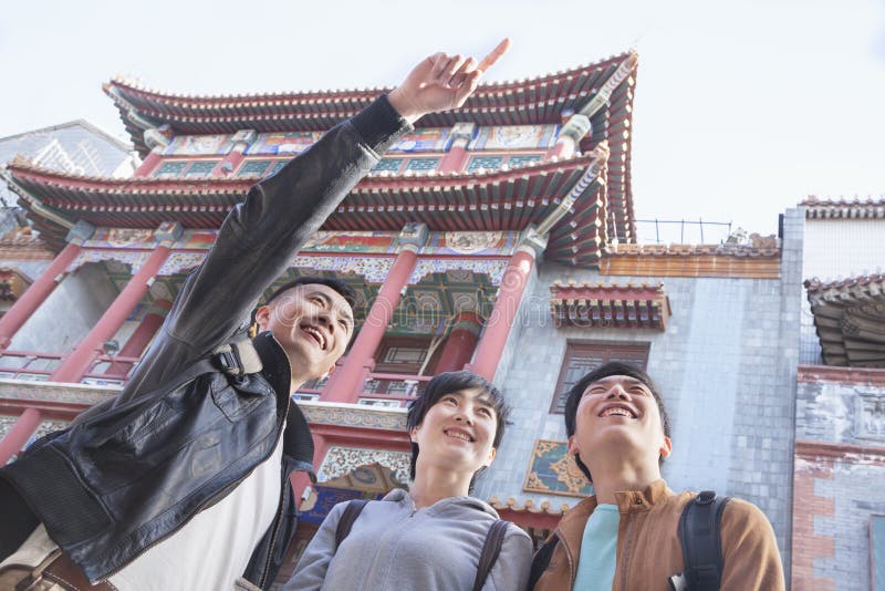 Three People Sightseeing, Looking and Pointing. Stock Image - Image of ...