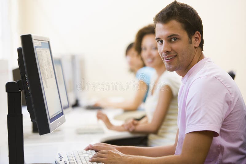 Three People Sitting in Computer Room Typing Stock Image - Image of ...