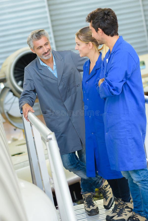 Three People Standing on Platform Next To Aircraft Stock Photo - Image ...