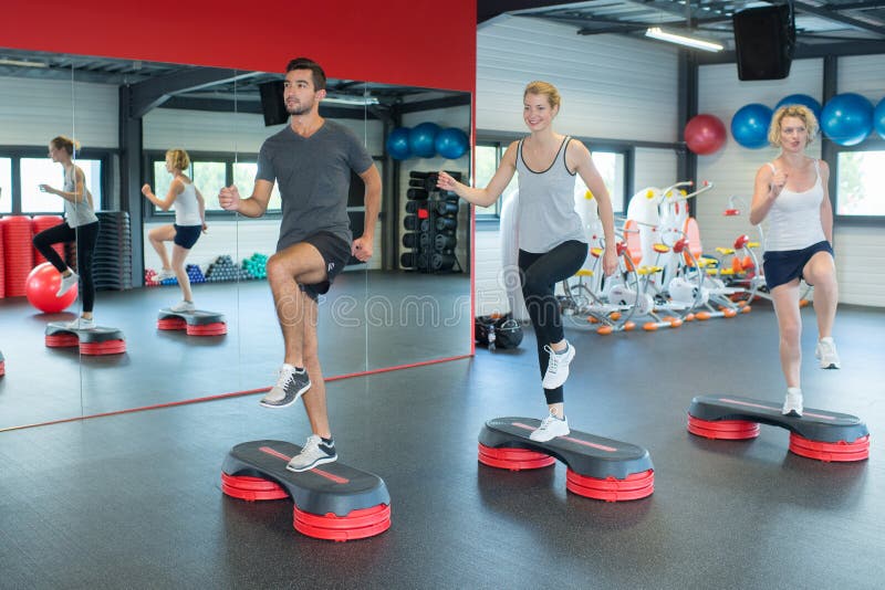 Three People Sychronised during Step Class Stock Photo - Image of ...