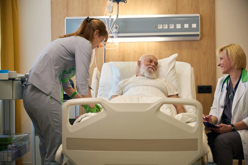 Three People Talking in a Hospital Room Stock Image - Image of ...