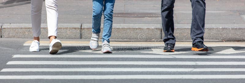 Three People are Walking Along a Pedestrian Crossing Stock Photo ...