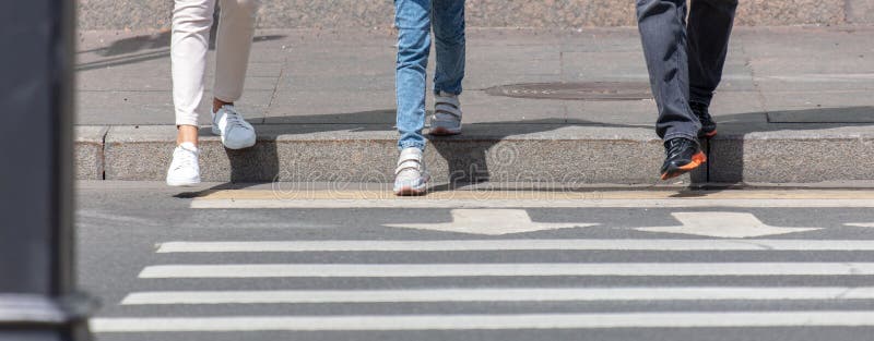 Three People are Walking Along a Pedestrian Crossing Stock Photo ...