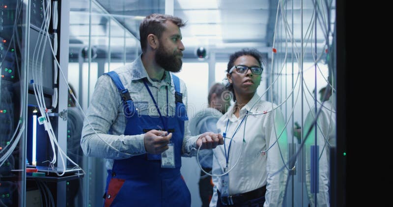 Three People Working in a Data Center Stock Photo - Image of system ...