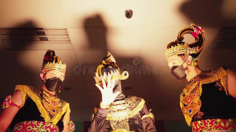 Three Performers in Traditional Javanese Dance Costumes with Elaborate ...