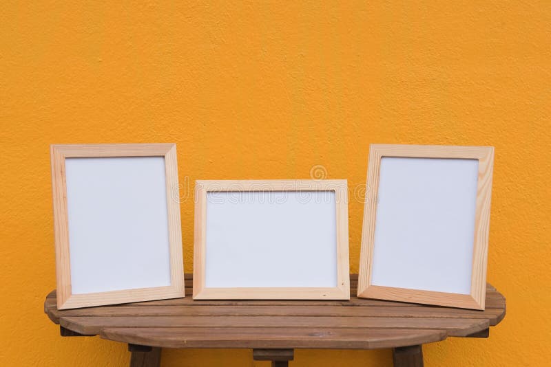 Three Photo Frame on a Wooden on Yellow Background . Stock Photo ...