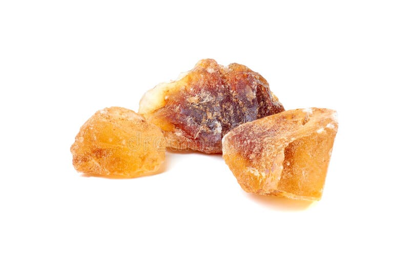 Three Pieces of Amber Sugar on White Stock Image - Image of sweet ...