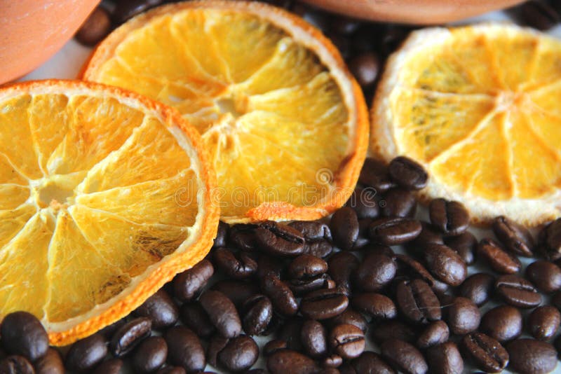 Three Pieces of Dried Orange and Many Coffee Beans on the Table on the ...