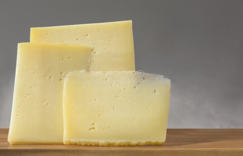 Three Pieces of Hard Cheese on a Gray Background Stock Image - Image of ...