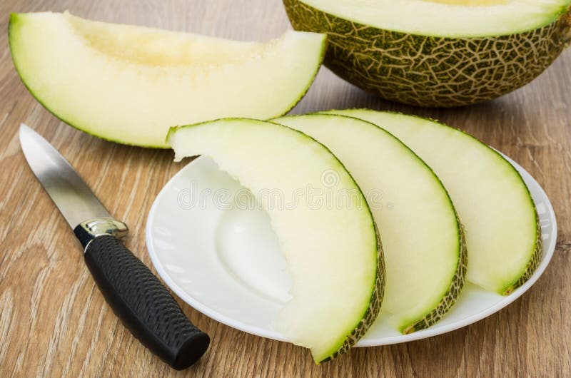Three Pieces of Melon in Plate, Kitchen Knife on Table Stock Image ...