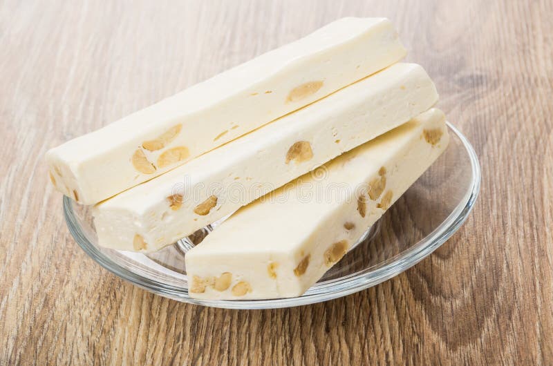 Three Pieces of Nougat with Nuts in Transparent Saucer Stock Photo ...