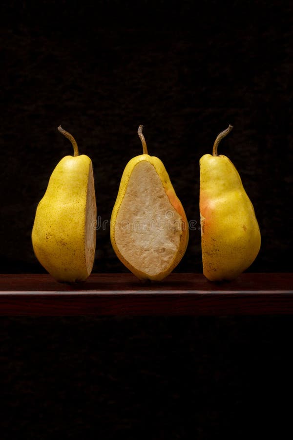 Three Pieces of Sliced Ripe Pears on a Wooden Shelf Stock Photo - Image ...