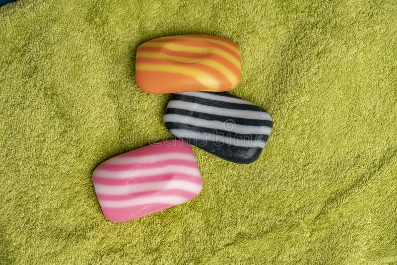 The Three Pieces of Striped Soap Bars on the Towel Textile Texture, Spa ...