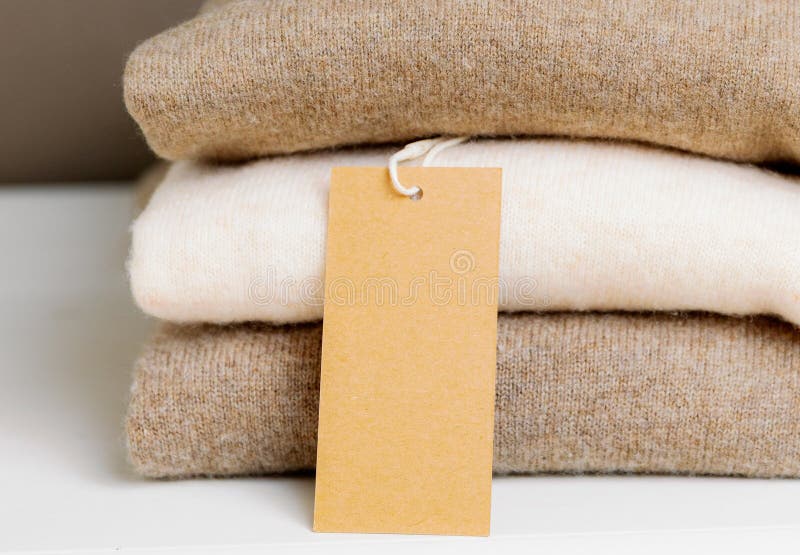 Three Thin Wool Sweaters with Tags on a Closet Shelf. Stock Image ...