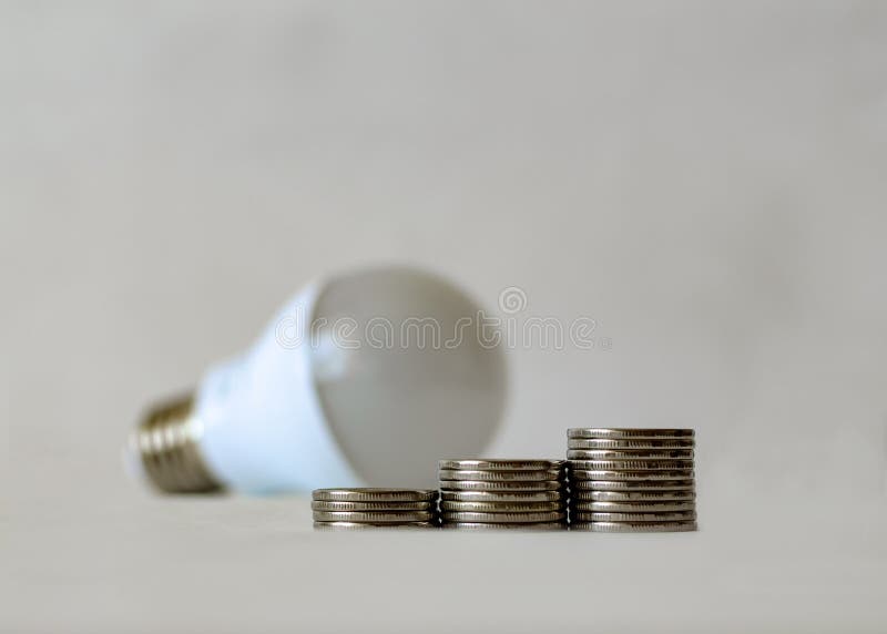 Coins on the Background of the LED Light Bulb Stock Image - Image of ...