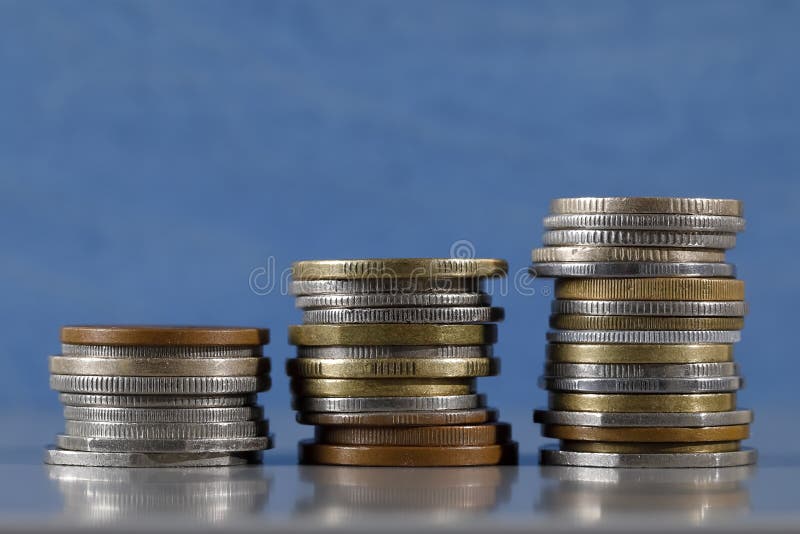Three Piles of Coins Represents an Improvement Stock Image - Image of ...