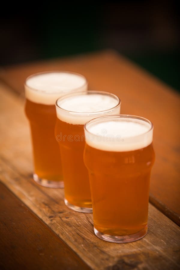 Three Pints of Beer in a Row Stock Image - Image of fresh, pint: 154571663