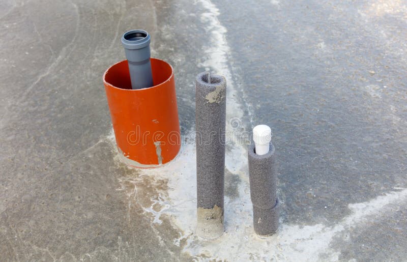 Three Pipes are on the Ground, One of Which is Orange Stock Image ...