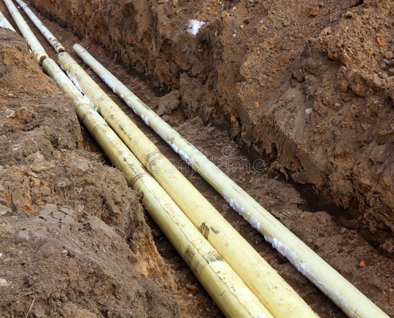 Three Pipes in the Trench in the Ground Diagonal Stock Photo - Image of ...